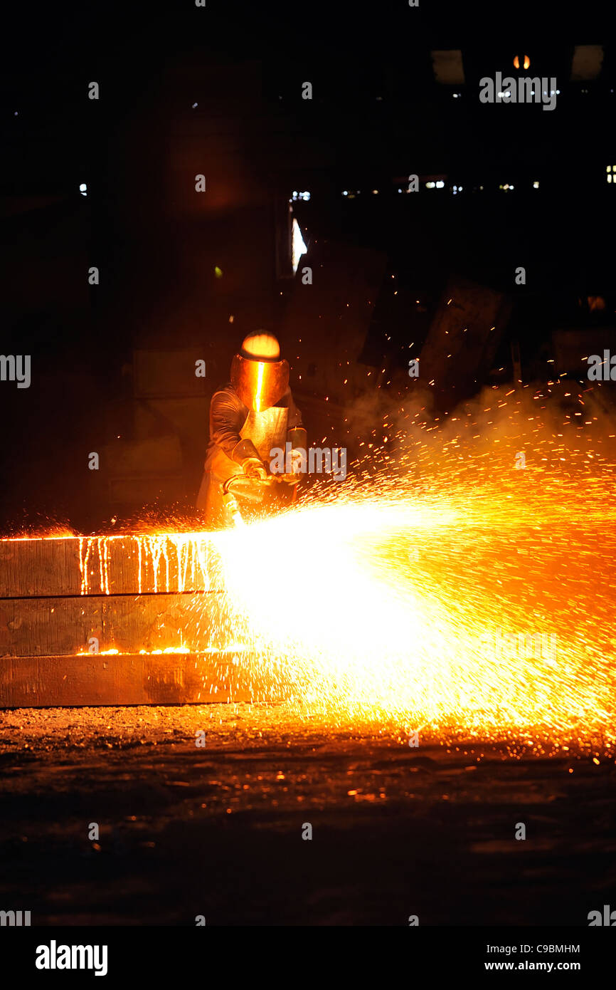 worker using torch cutter to cut through metal Stock Photo - Alamy
