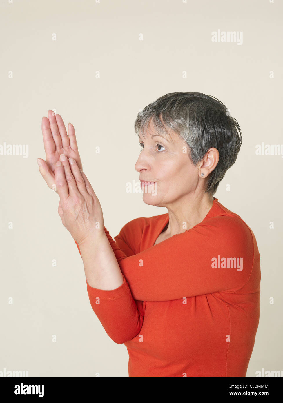 Senior woman twisting her hands Stock Photo - Alamy