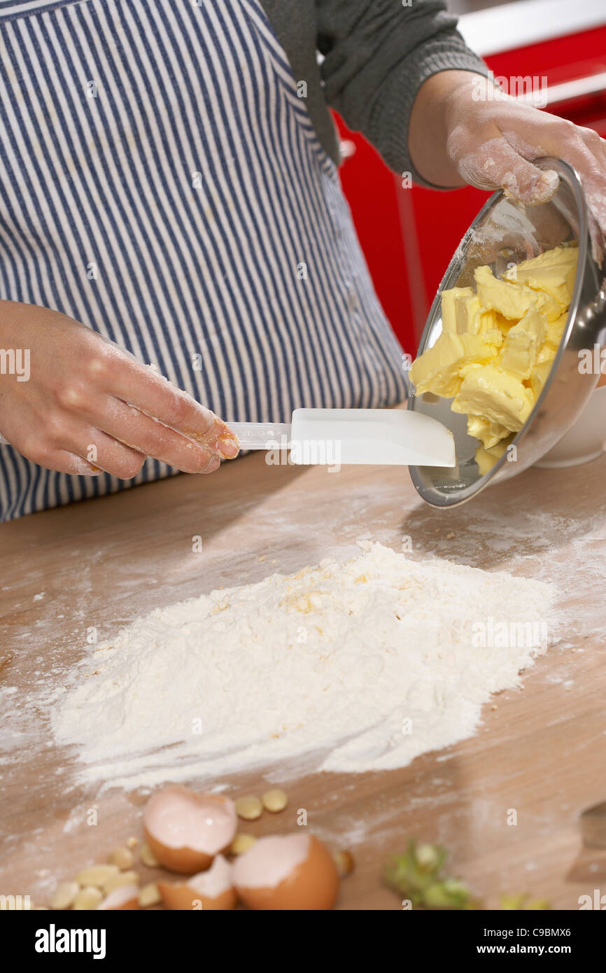 Woman adding ingredients bowl baking hi-res stock photography and ...