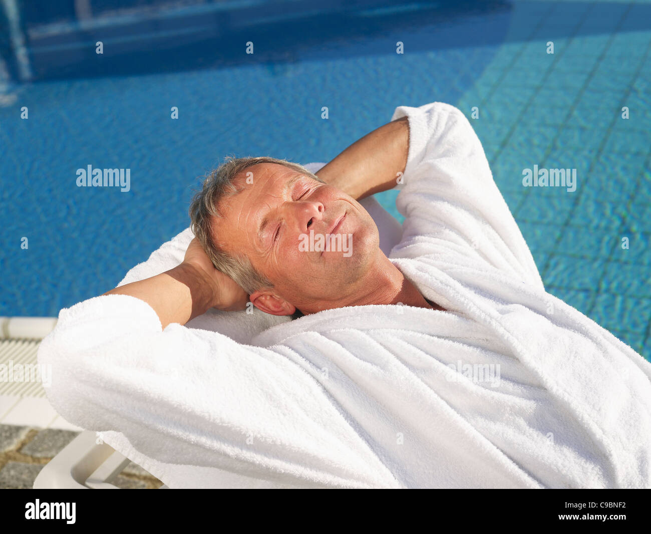 Mature man resting on sun lounger Stock Photo - Alamy
