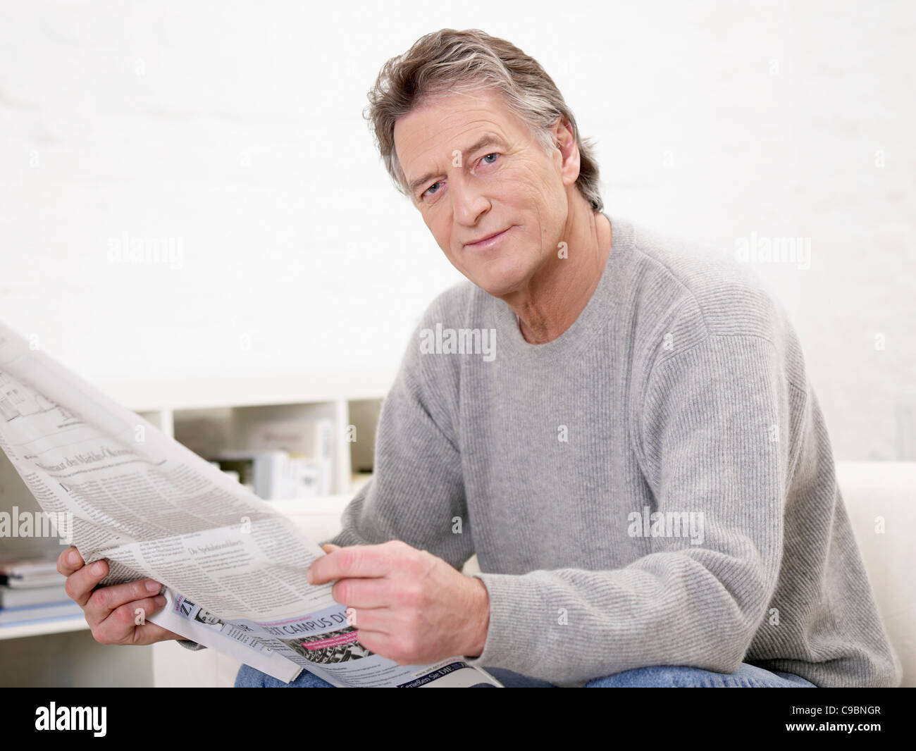 Germany, Hamburg, Senior man with newspaper, portrait Stock Photo - Alamy