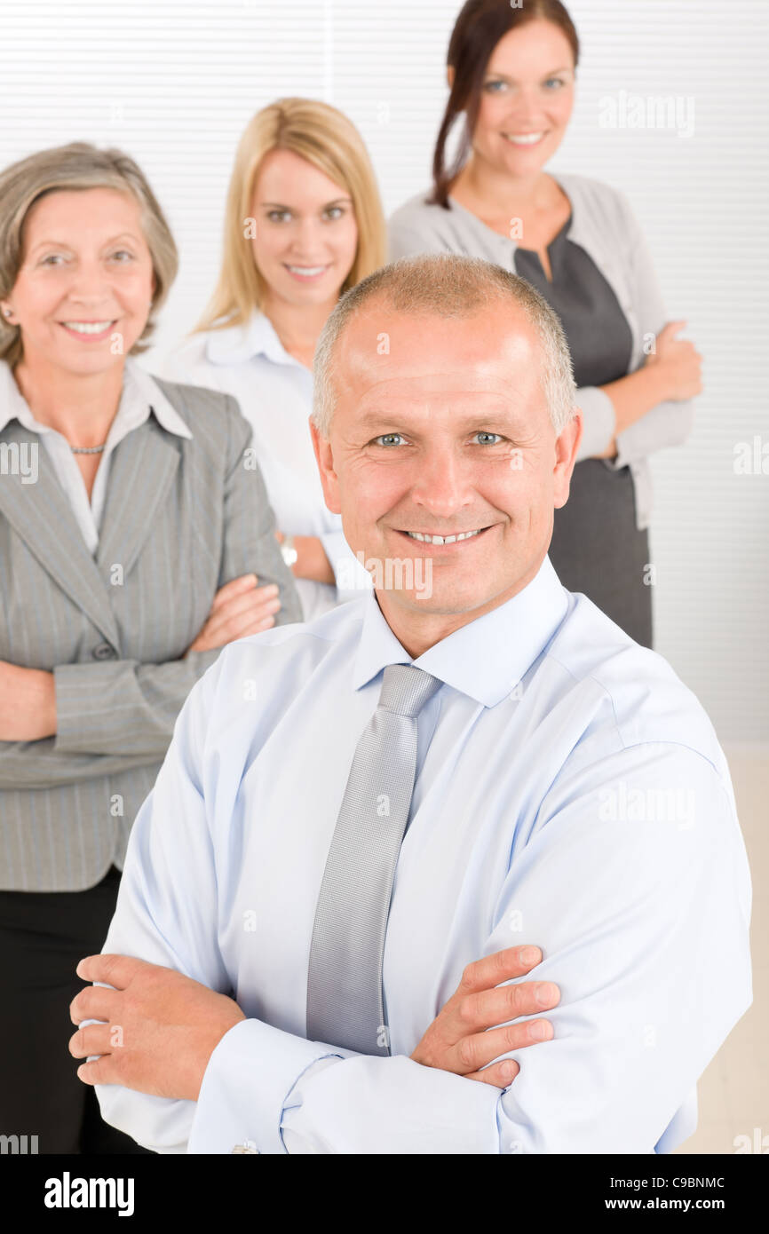 Business team senior businessman with attractive happy colleagues in ...