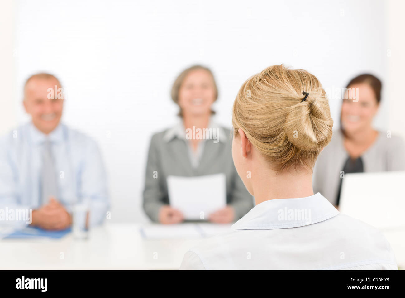 Business interview young woman being examined by professional manager ...
