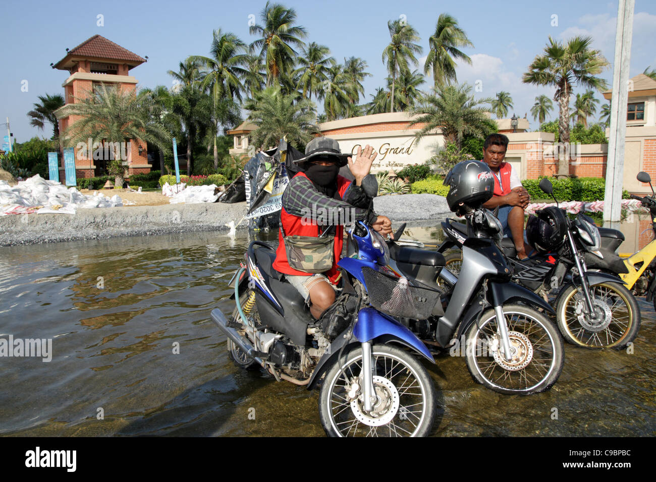 Motorcycle taxi , Floodwaters near a village at Pakkred , Nonthaburi ...