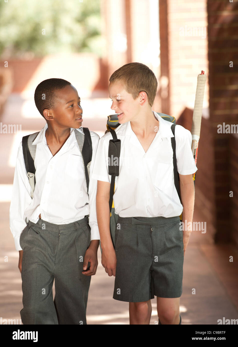 Two boys walking down school corridor, Johannesburg, Gauteng Province ...