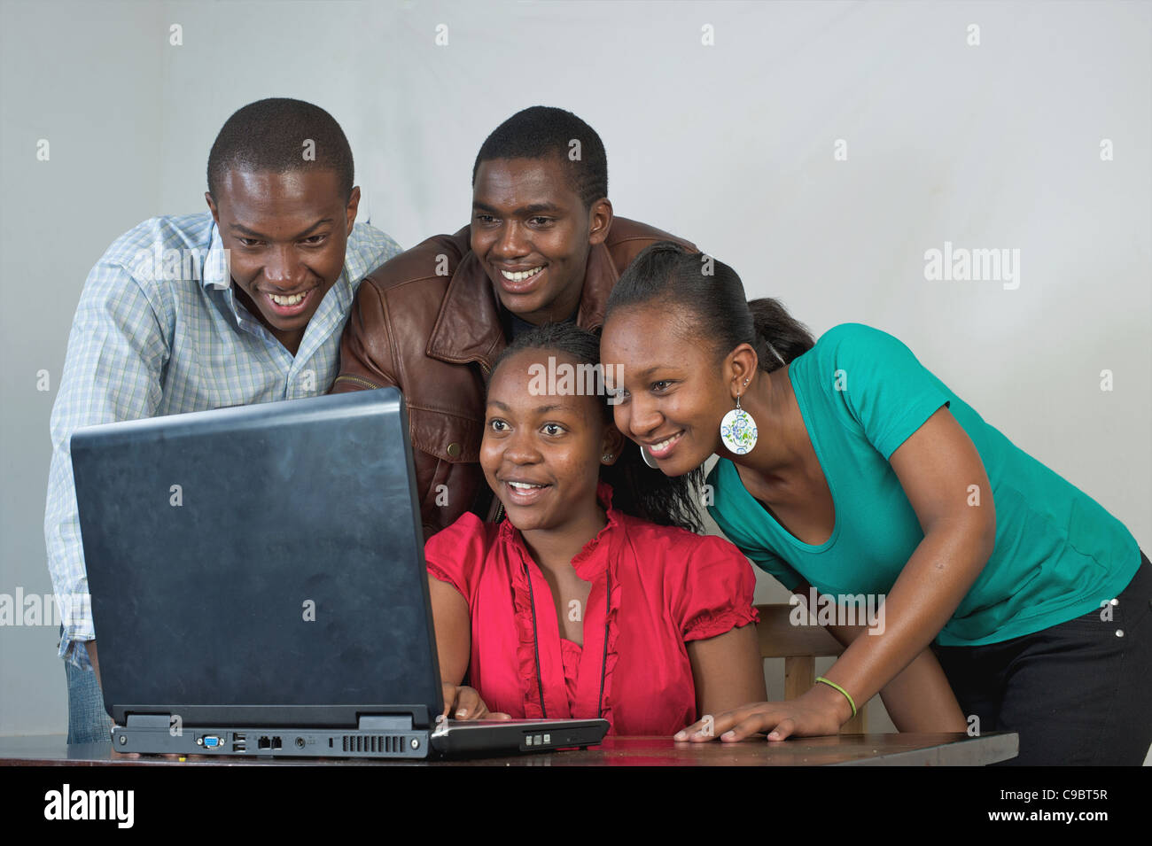 Kenyan students gathered around laptop, Nairobi, Kenya Stock Photo - Alamy