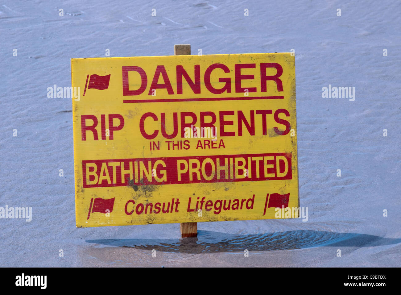 a warning sign on a beach in ballybunion ireland Stock Photo - Alamy