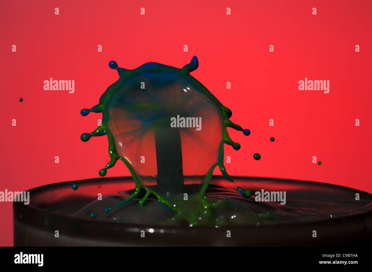 High-speed flash photograph liquid droplets. The droplet lands in the ...