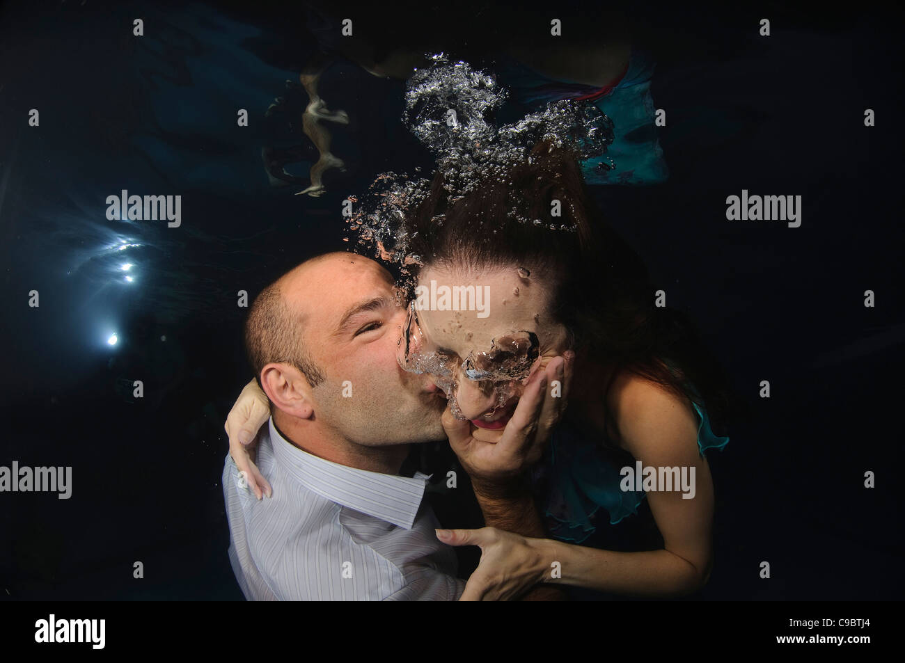 Romantic couple kissing swimming pool hi-res stock photography and ...