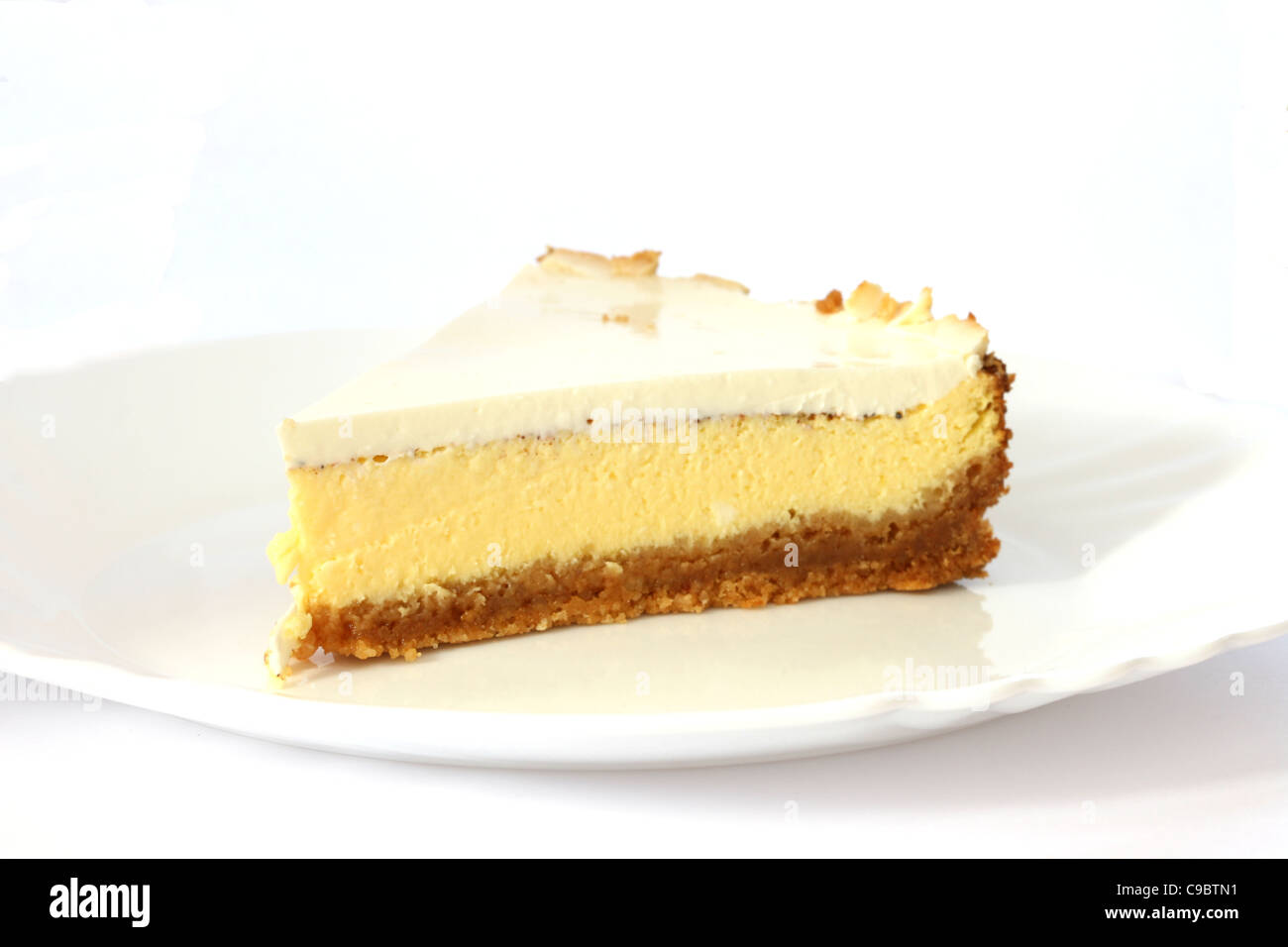 Layered cheesecake case on white plate and background Stock Photo - Alamy