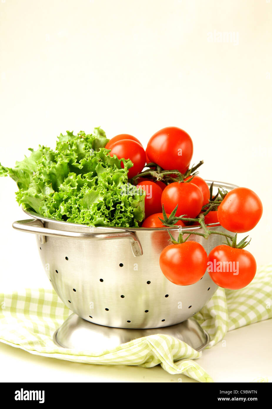 Fresh vegetables in metal colander over white Stock Photo - Alamy