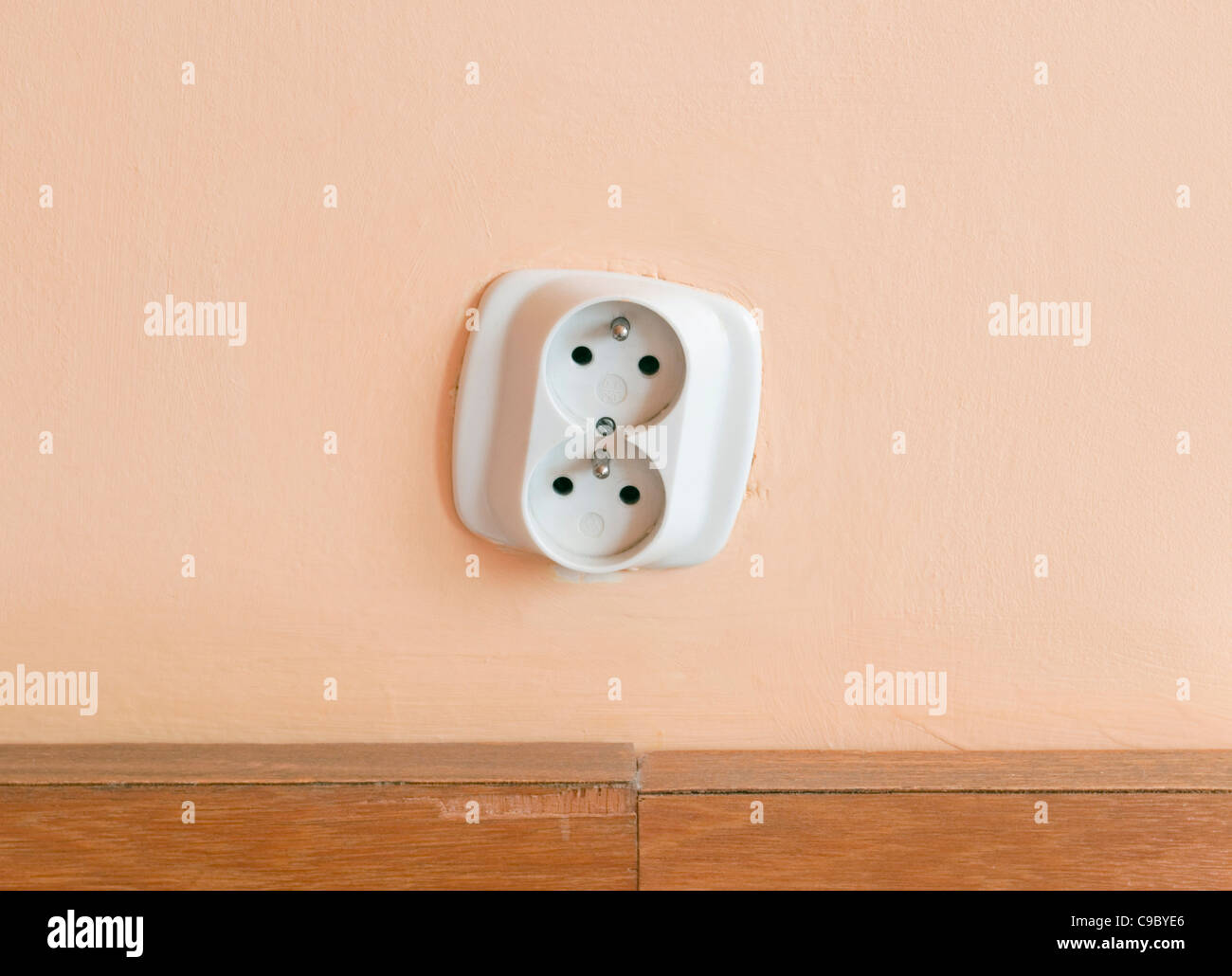 crooked plug socket on wall Stock Photo - Alamy