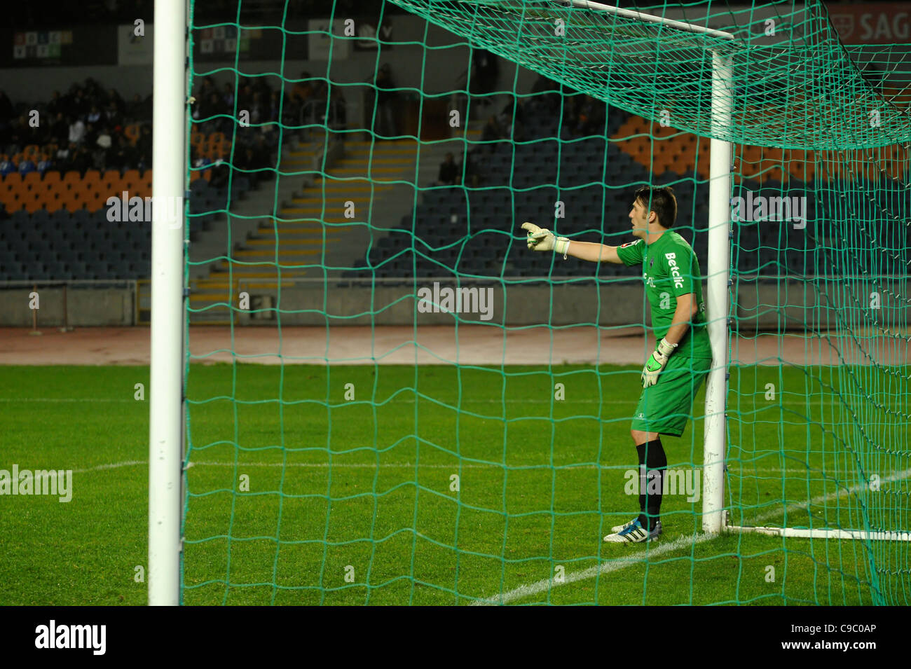 Football goalkeeper organizing his team by yelling at his teammates ...
