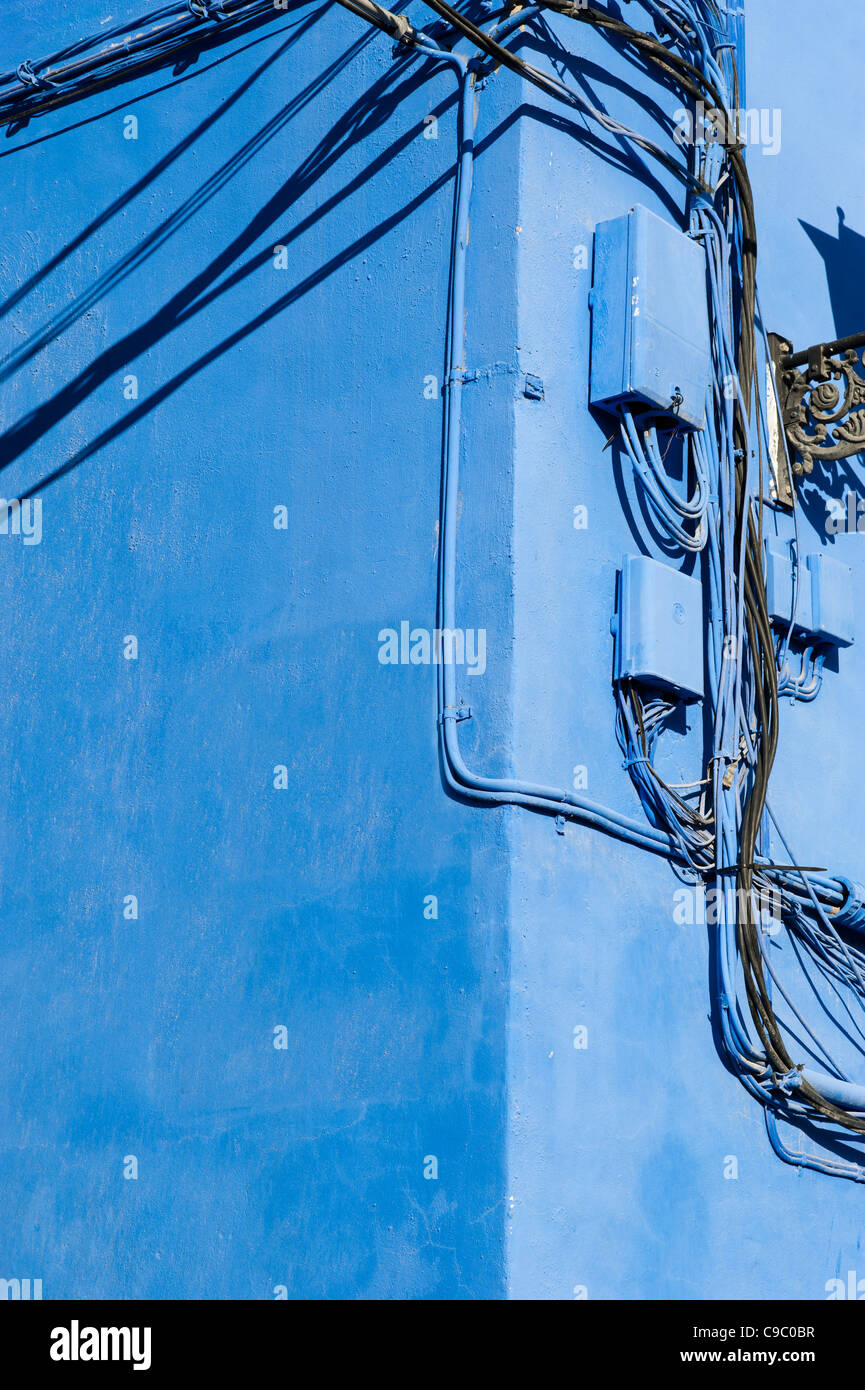 Detail of electricity wiring on a traditional blue Mediterranean facade ...
