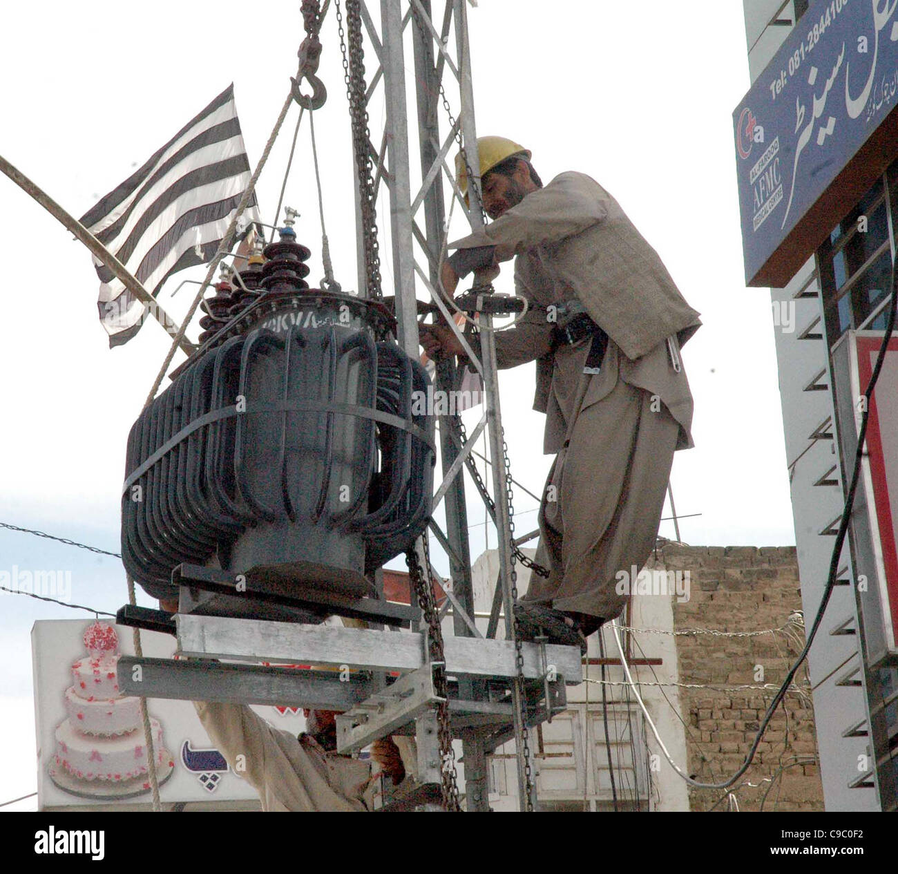 WAPDA employees busy in installation work of a pole- mounted ...