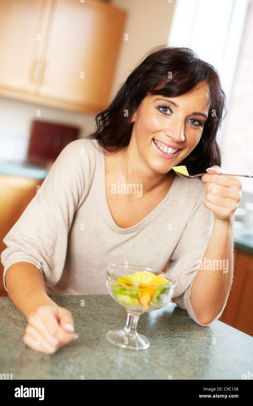 Woman eating fruit Stock Photo - Alamy