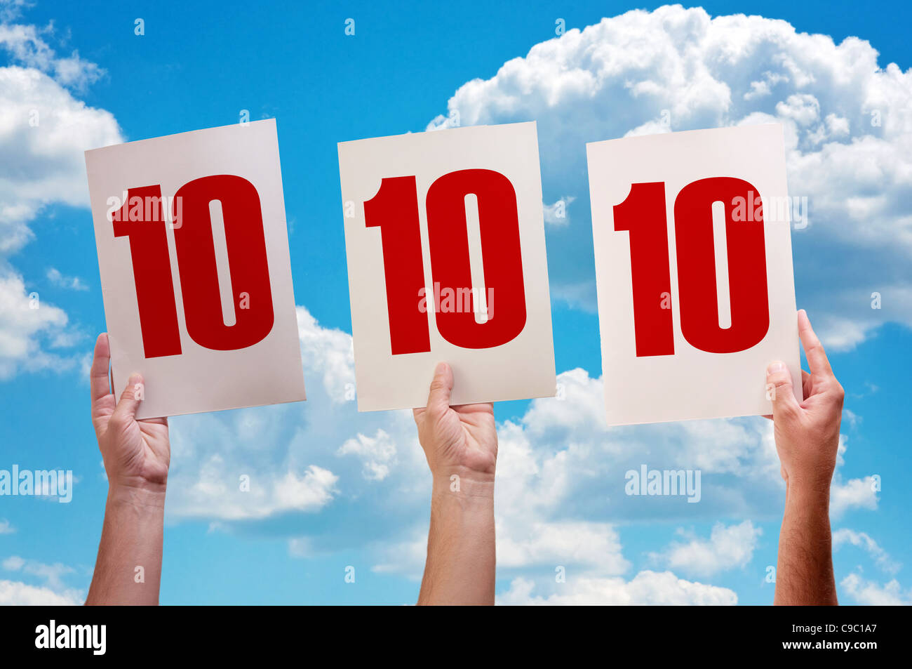 White paper with number ten in male hands on blue sky background Stock ...