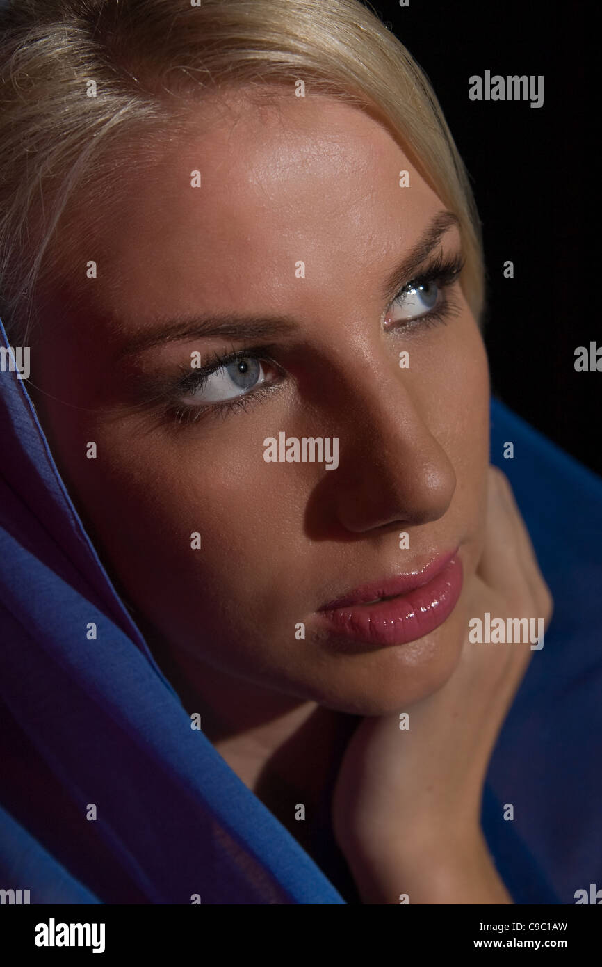 Portrait of young woman in low lighting Stock Photo - Alamy