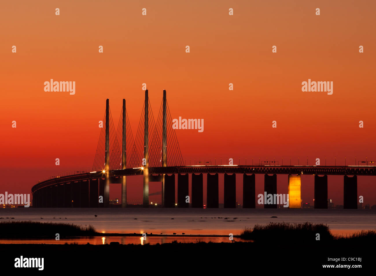 The bridge between Copenhagen Denmark and Malmo Sweden in sunset over ...