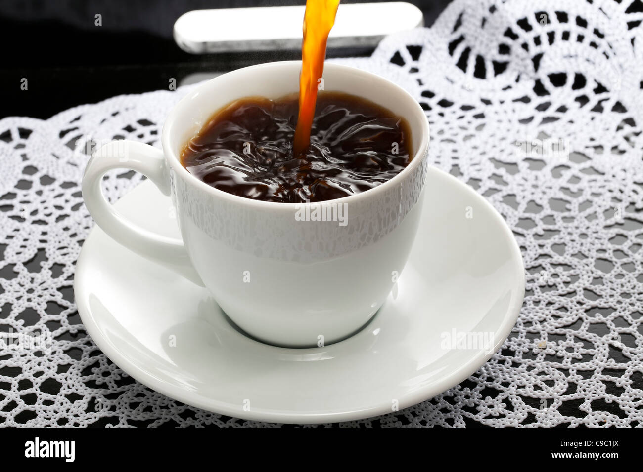 Coffee being poured into white cup Stock Photo - Alamy