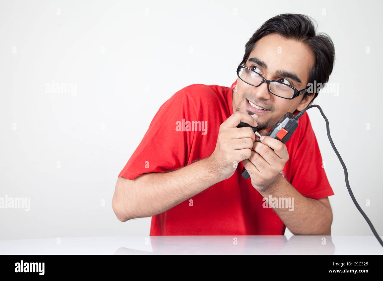 Nerd possessive about his retro game joystick controller Stock Photo ...