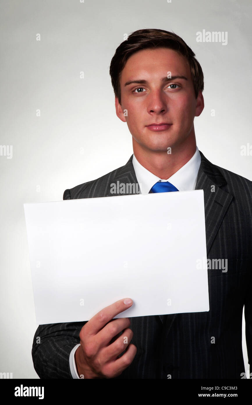 man in business suit holding up a blank white card Stock Photo - Alamy