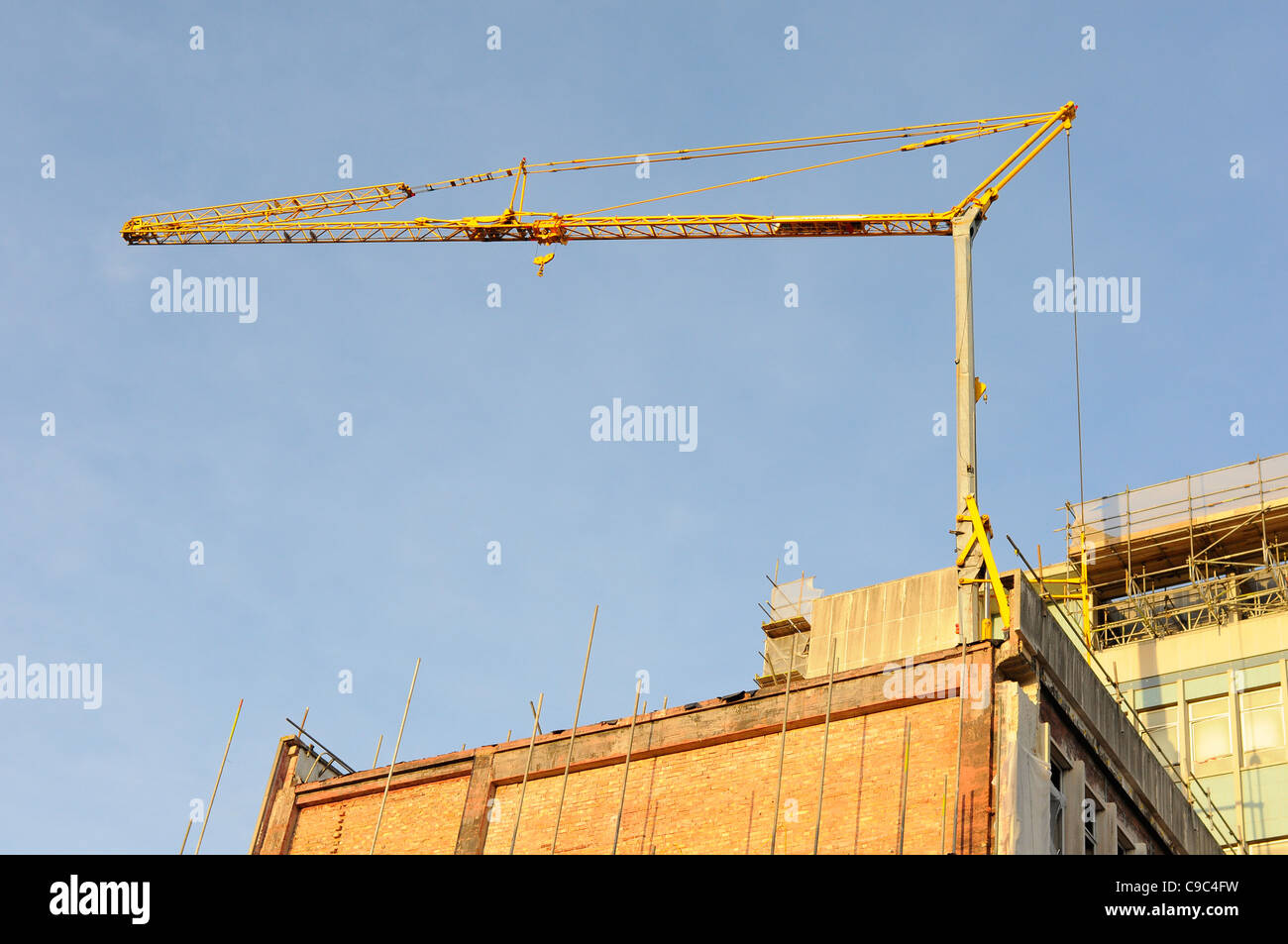 Construction crane over commercial buildings being renovated Stock ...