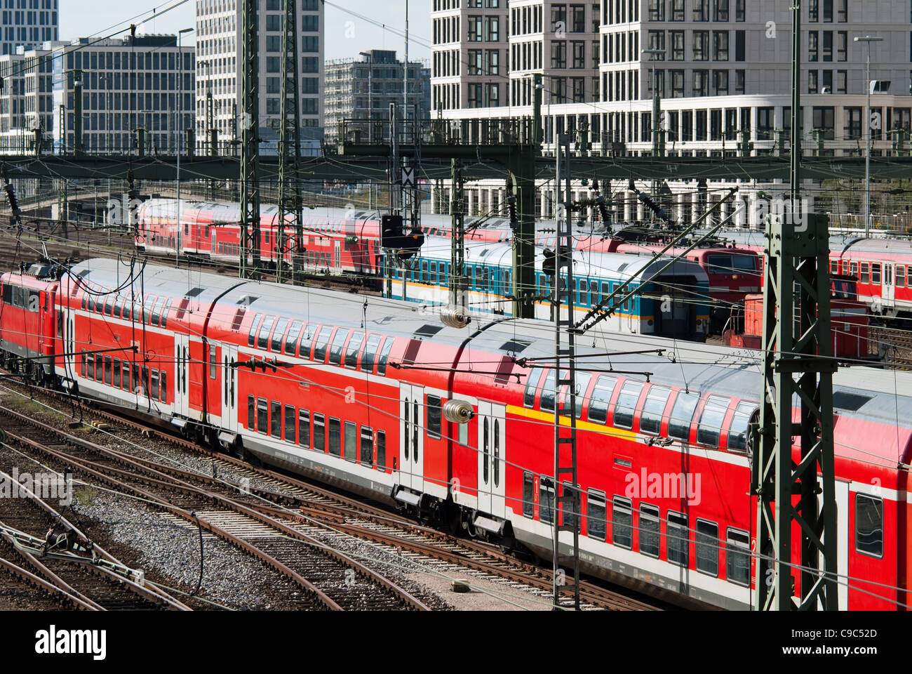many trains in the railway station with houses in the background Stock ...