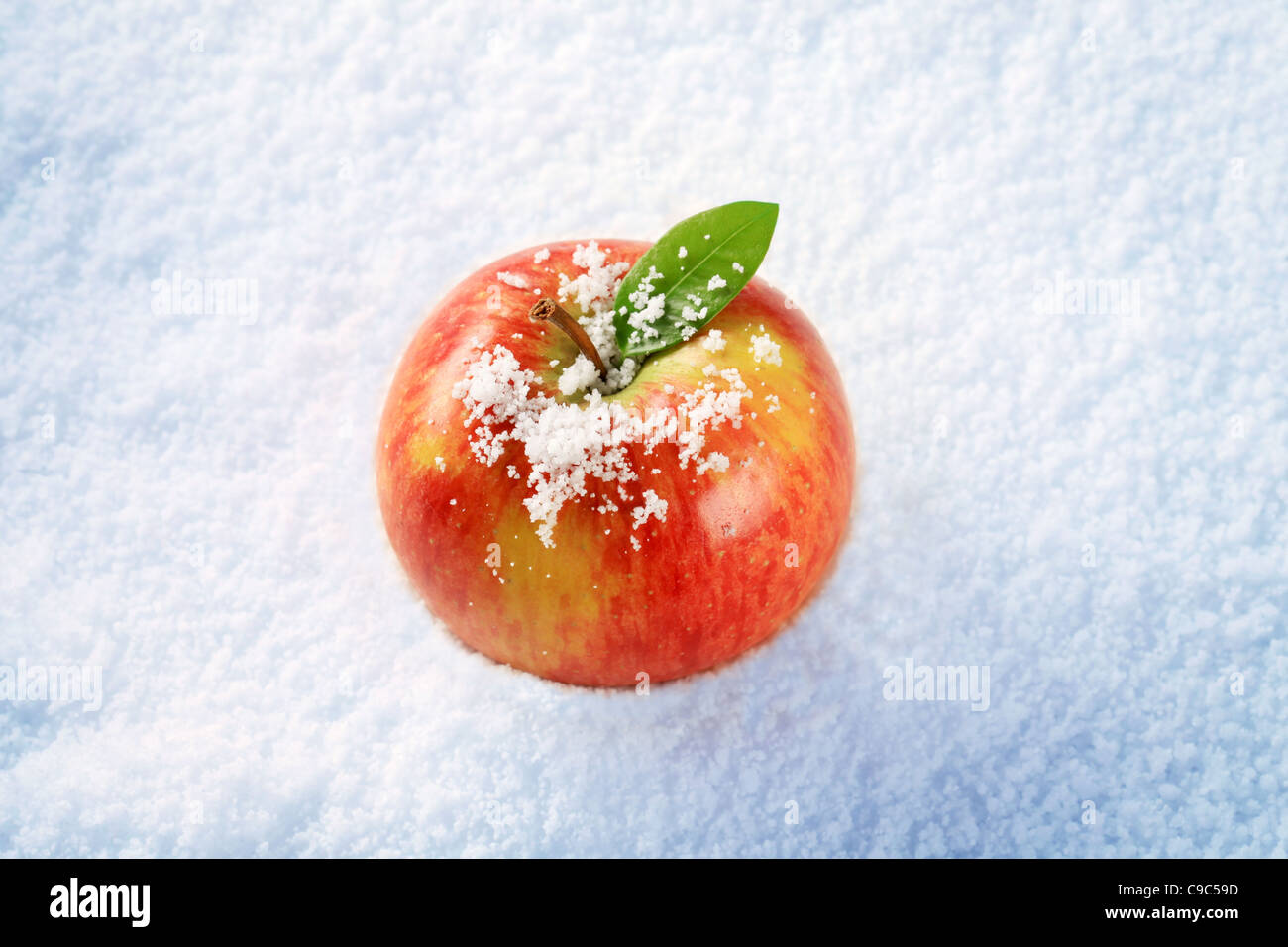 Fresh red apple in snow - closeup Stock Photo - Alamy