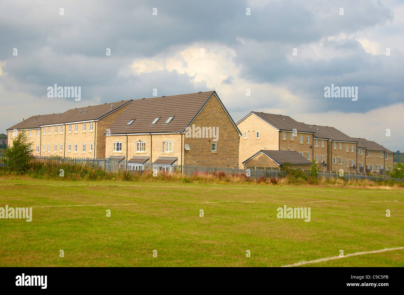 New build houses backing onto a football pitch / sports ground Stock ...