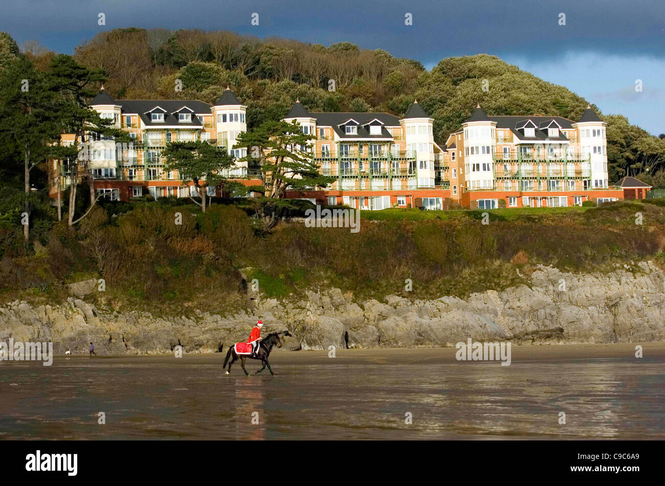 Santa riding a horse at Caswell Bay near Swansea in South Wales Stock ...