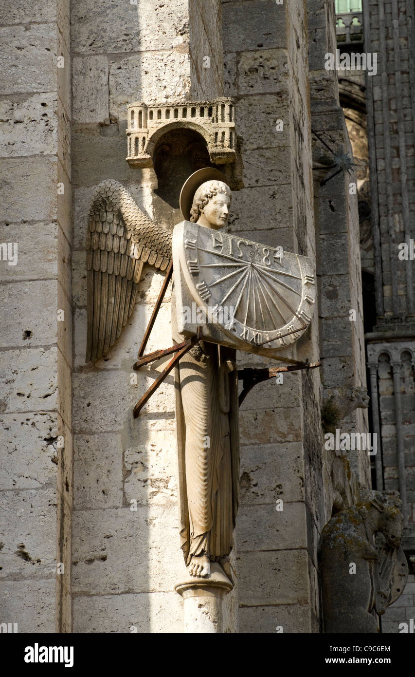 Sculpture of an angel holding a sundial on a corner of Chartres ...