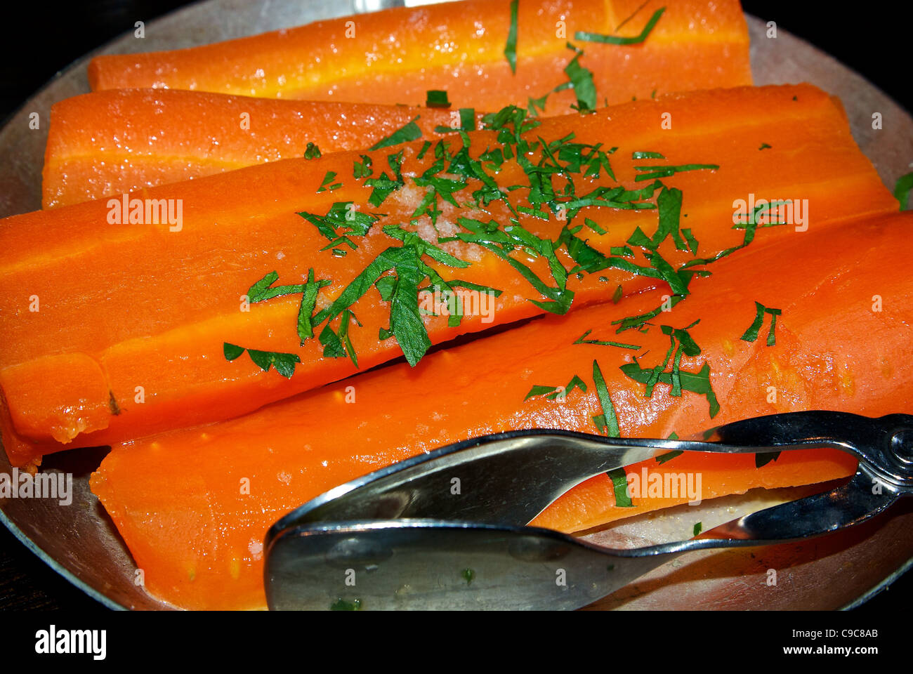 Candied buttery carrots julienned basil garnish side dish Stock Photo ...