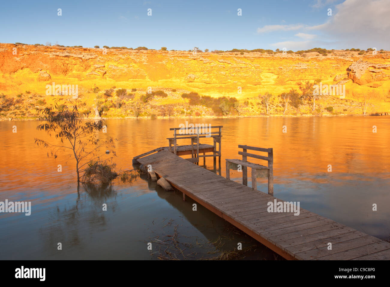 Late afternoon sun on the golden cliffs on the Murray River at Walker ...