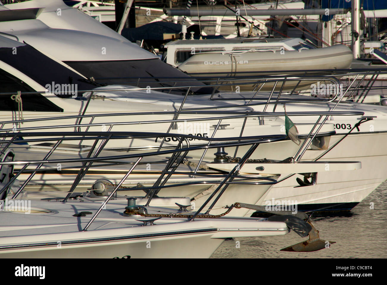 Powerboats yachts lined up at berths in marina Stock Photo - Alamy