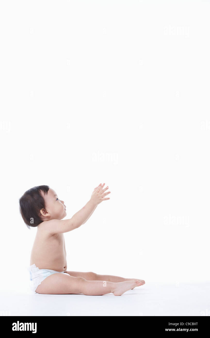 Baby boy in nappy standing Stock Photo - Alamy