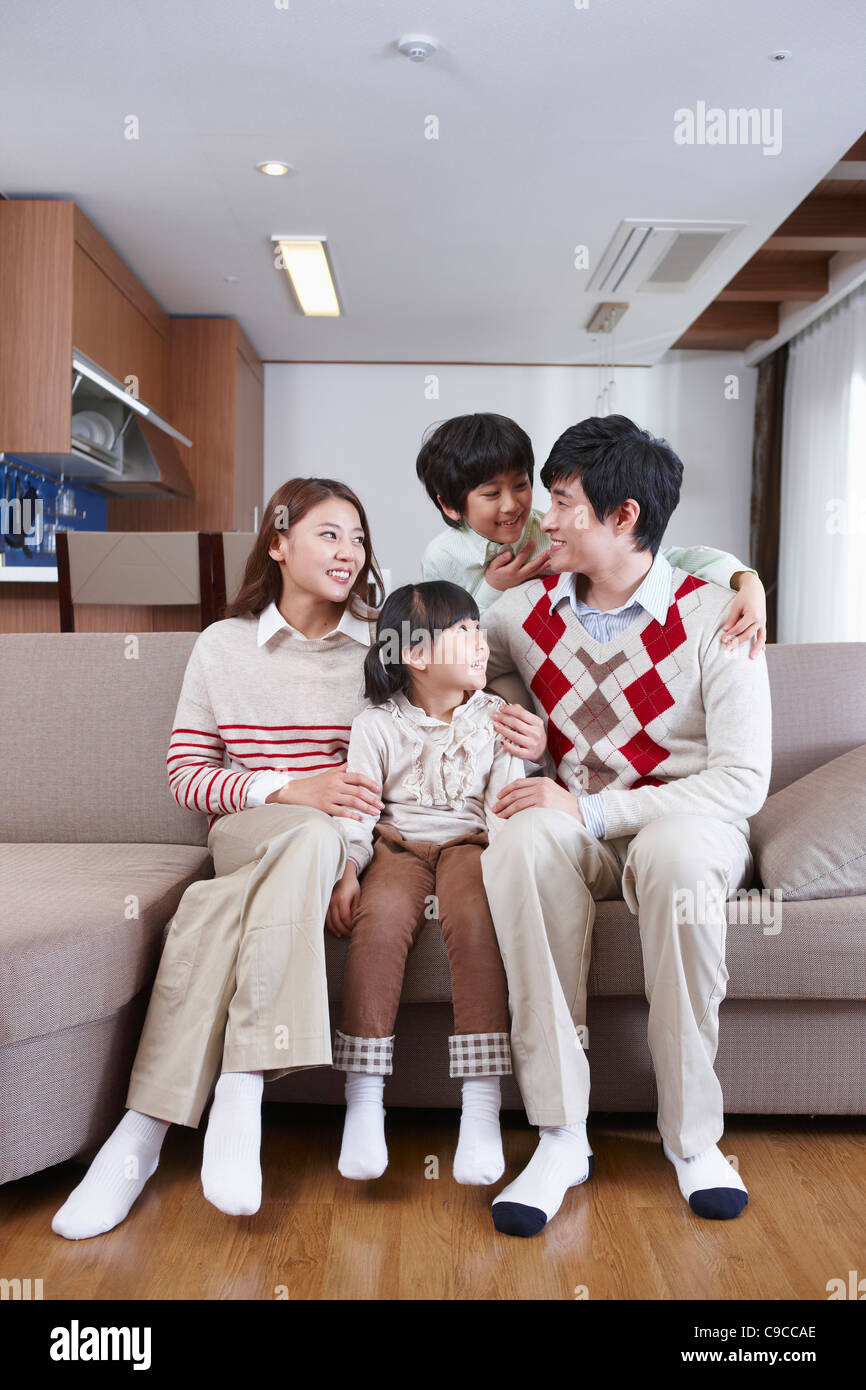 Happy family talking on the sofa Stock Photo - Alamy