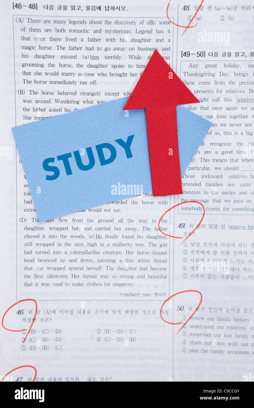 Marked test paper and a STUDY message with red arrow Stock Photo - Alamy