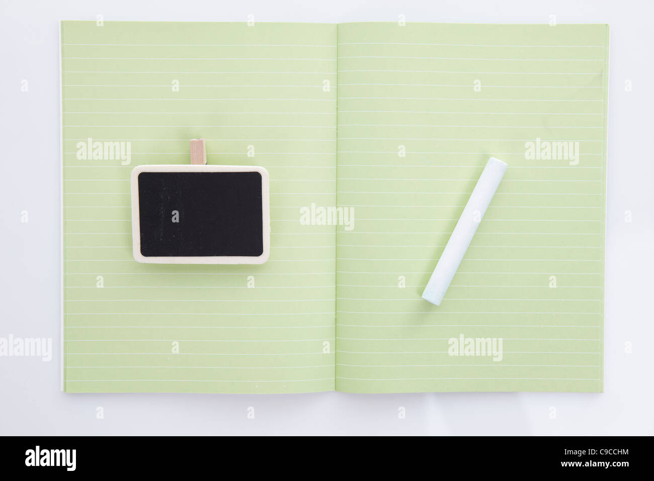 An open notebook with a mini blackboard and chalk Stock Photo - Alamy