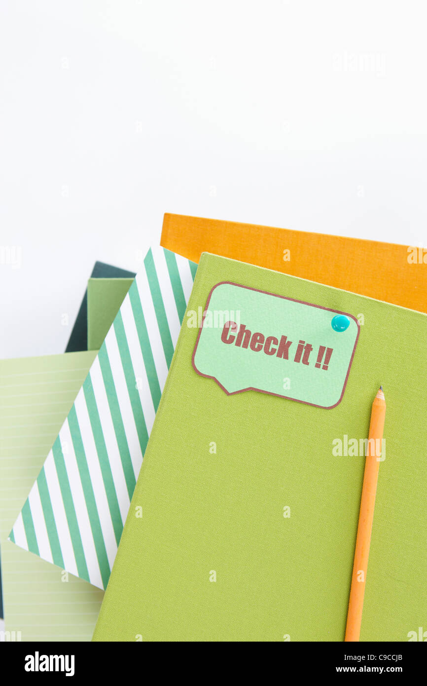 Books and Check it!! message with orange pencil Stock Photo - Alamy