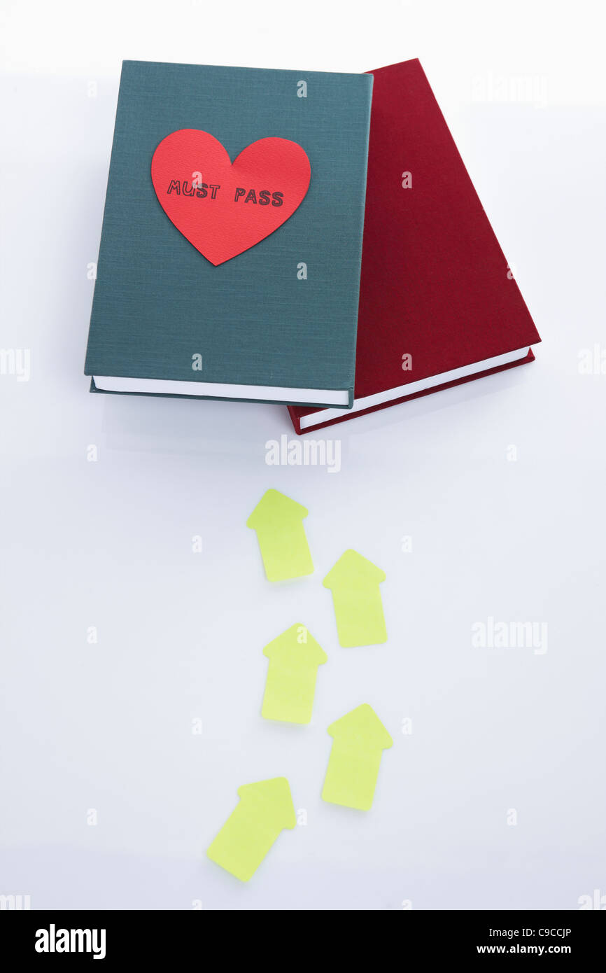 Arrows toward books with a MUST PASS message Stock Photo - Alamy