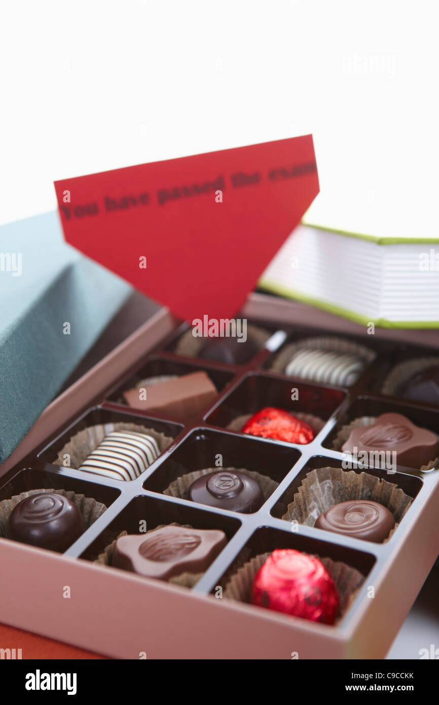 A box of chocolate in the middle of books Stock Photo - Alamy