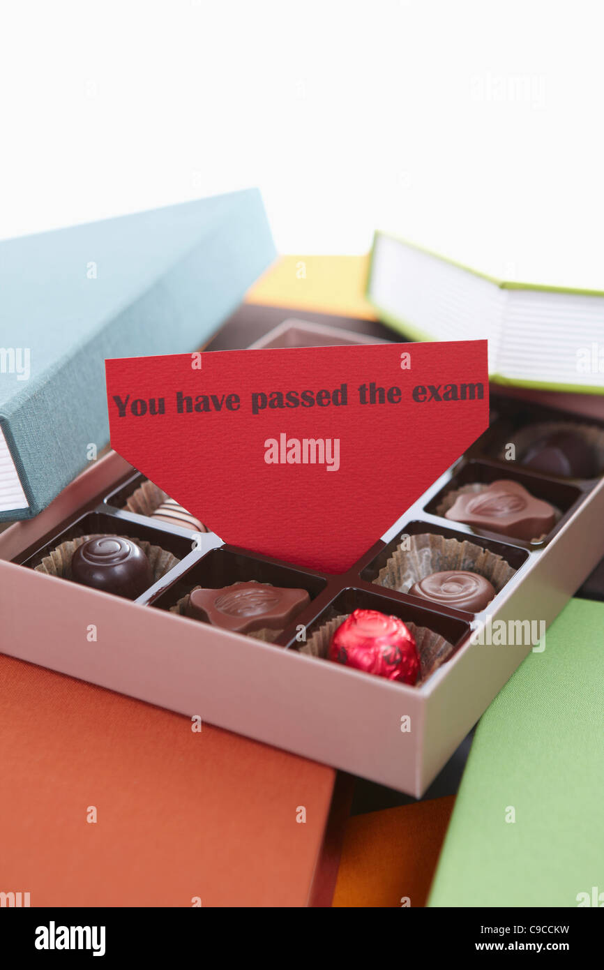 A box of chocolate in the middle of books with message Stock Photo - Alamy