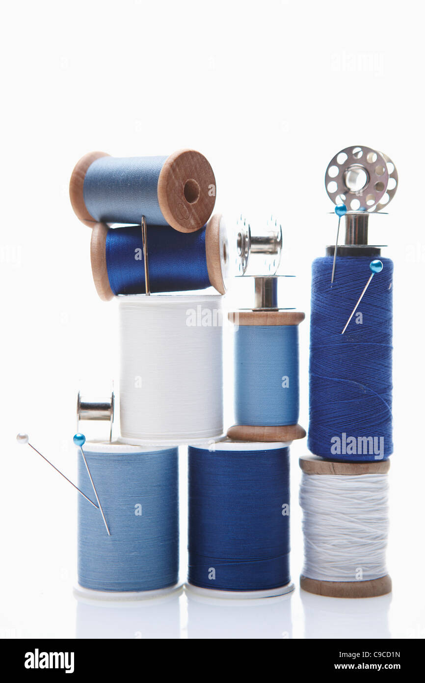 Various reel of threads and sewing tools in blue Stock Photo - Alamy