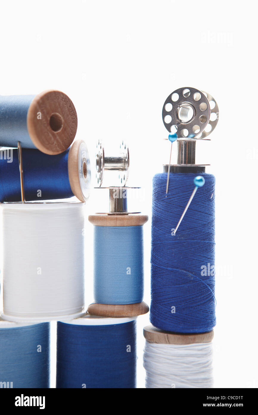 Various reel of threads and sewing tools in blue Stock Photo - Alamy