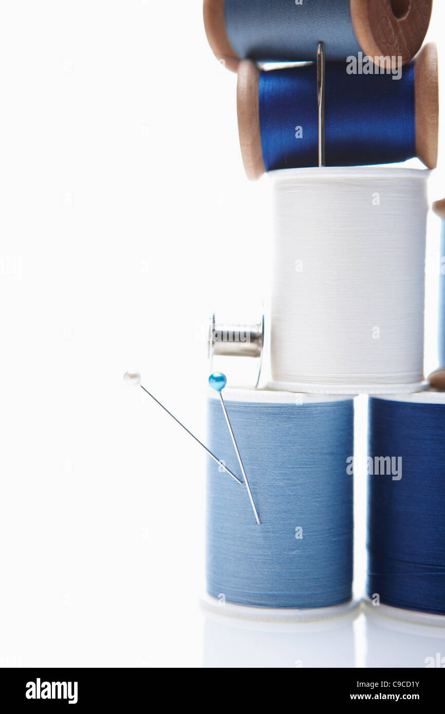 Various reel of threads and sewing tools in blue Stock Photo - Alamy