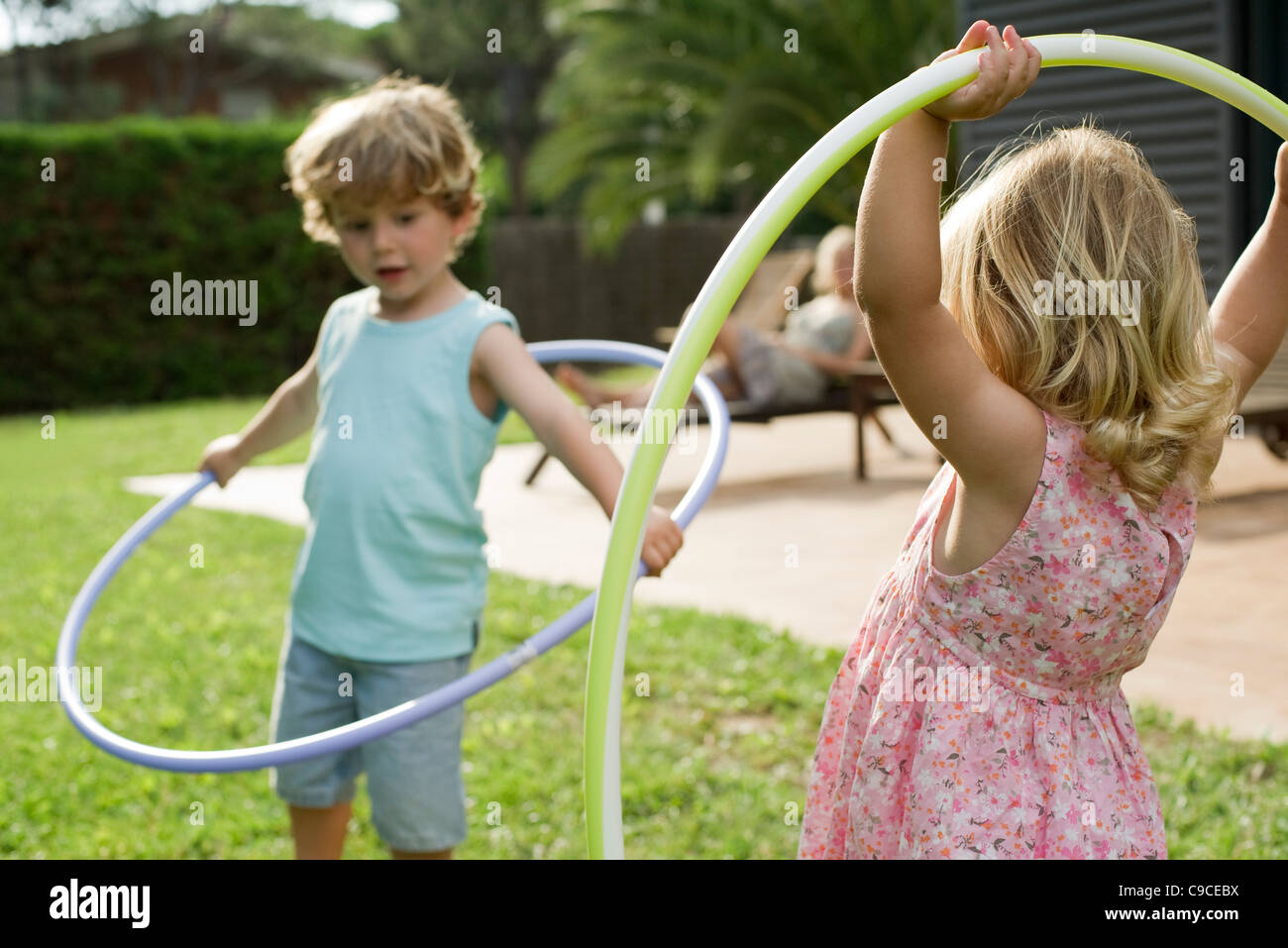 Children playing with plastic hoops outdoors Stock Photo - Alamy