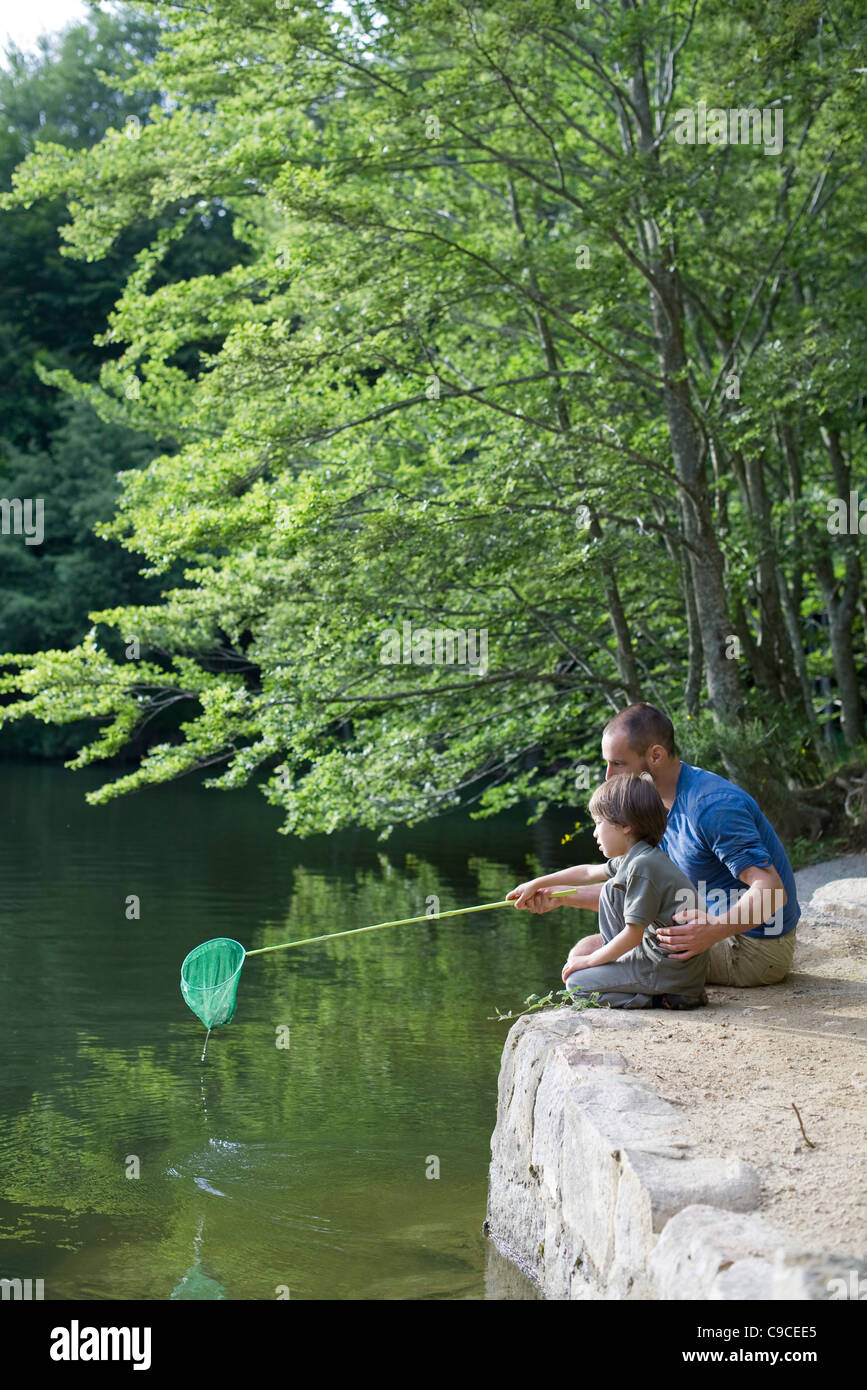Father teaching son how to fish Stock Photo - Alamy