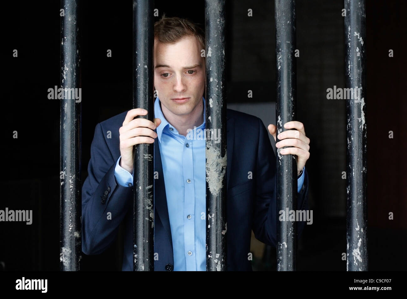 Businessman in jail Stock Photo - Alamy