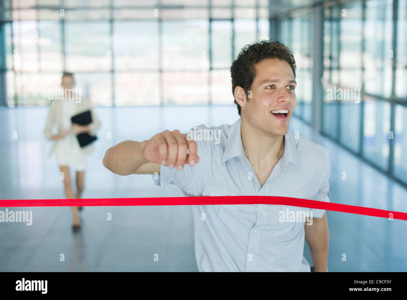 Businessman crossing finishing line Stock Photo - Alamy